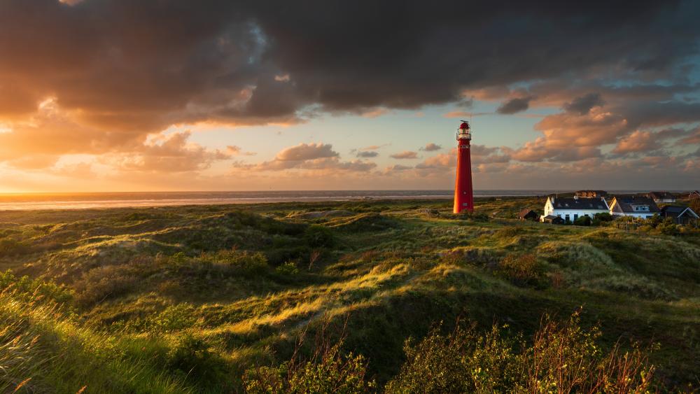 Sunset Over Schiermonnikoog Red Lighthouse And Coastal Dunes - backiee