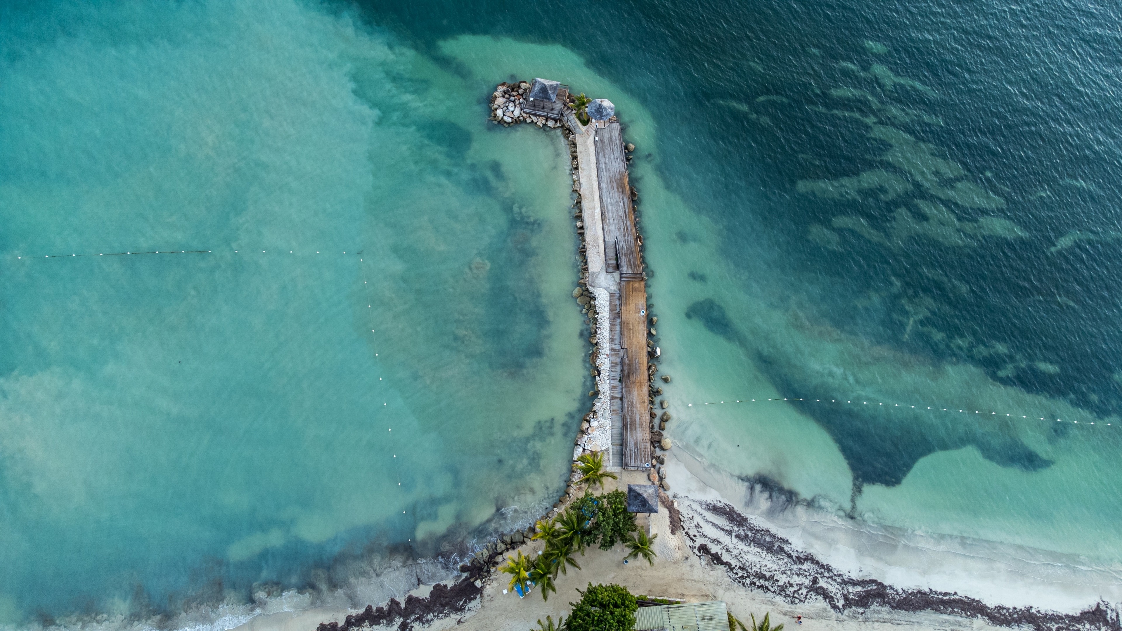 Montego Bay Pier Over Turquoise Caribbean Waters in Jamaica 4K - backiee