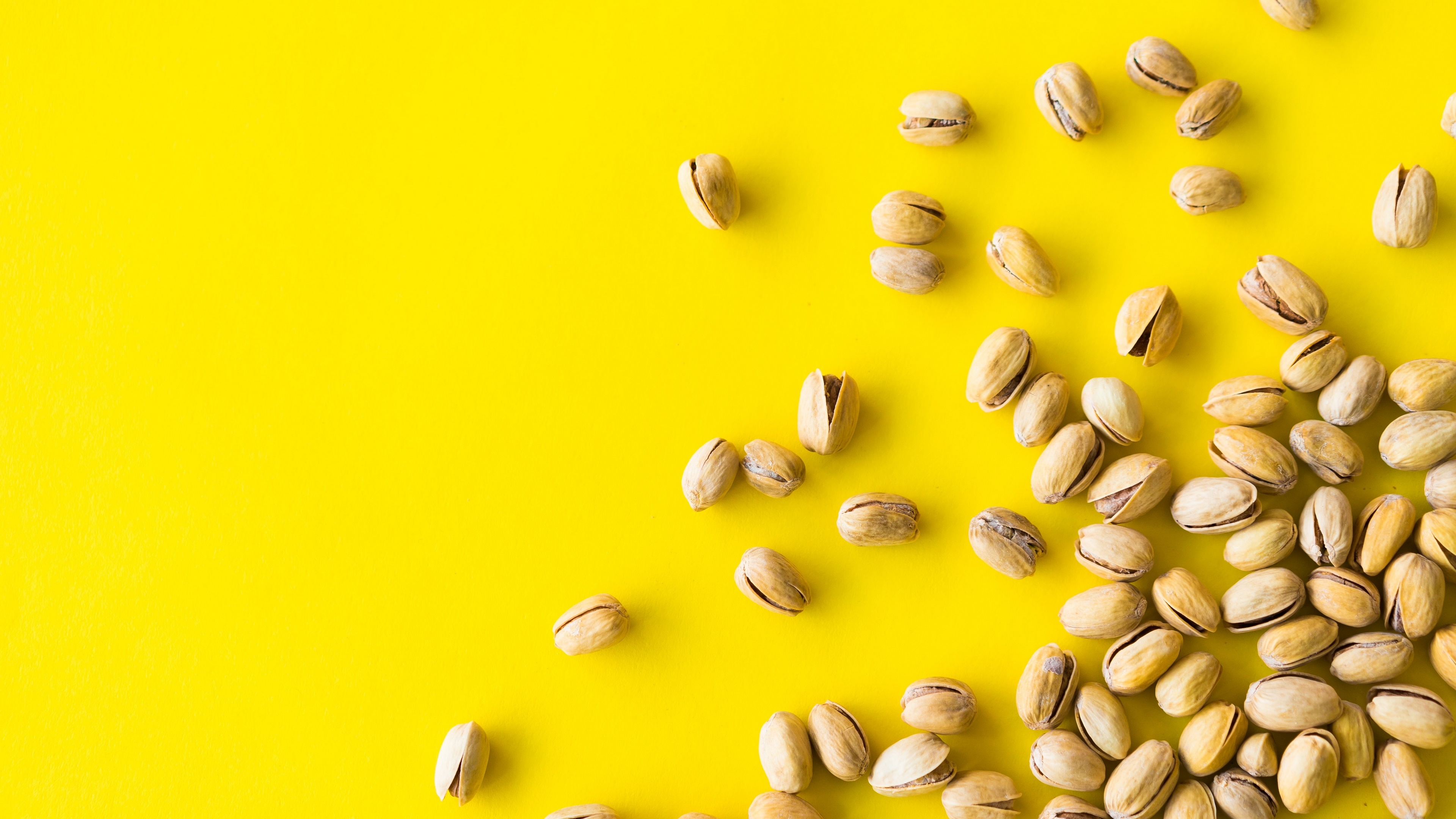 Pistachio Scatter on Vibrant Yellow Minimal Foodie 4K Wallpaper - backiee