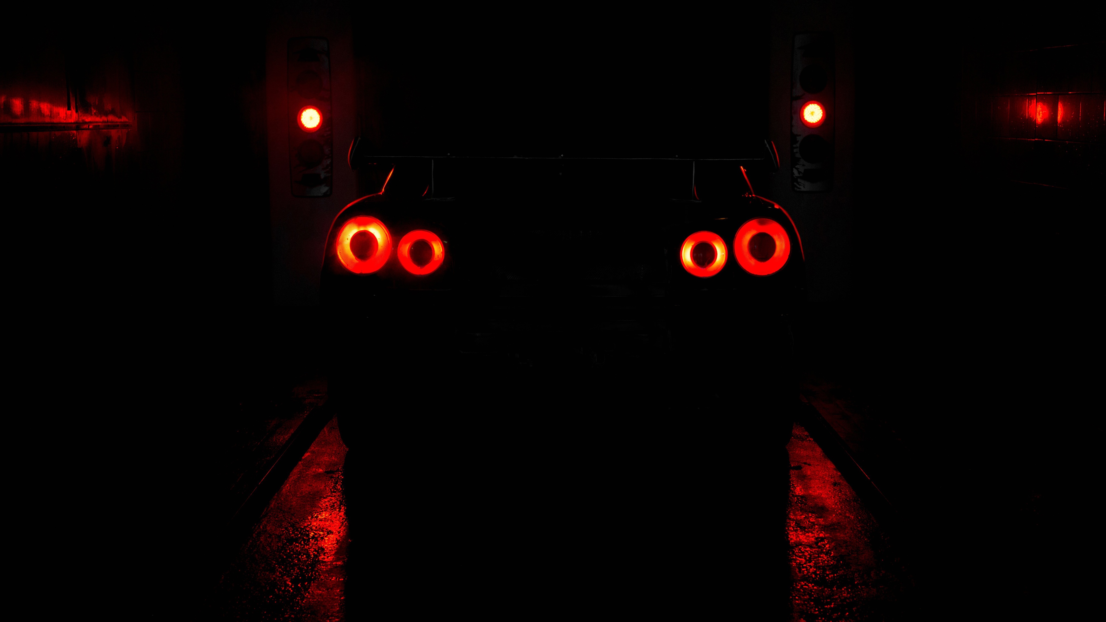 Shadowed Nissan Skyline GT-R R34 Glowing Red Night Tail Lights - backiee