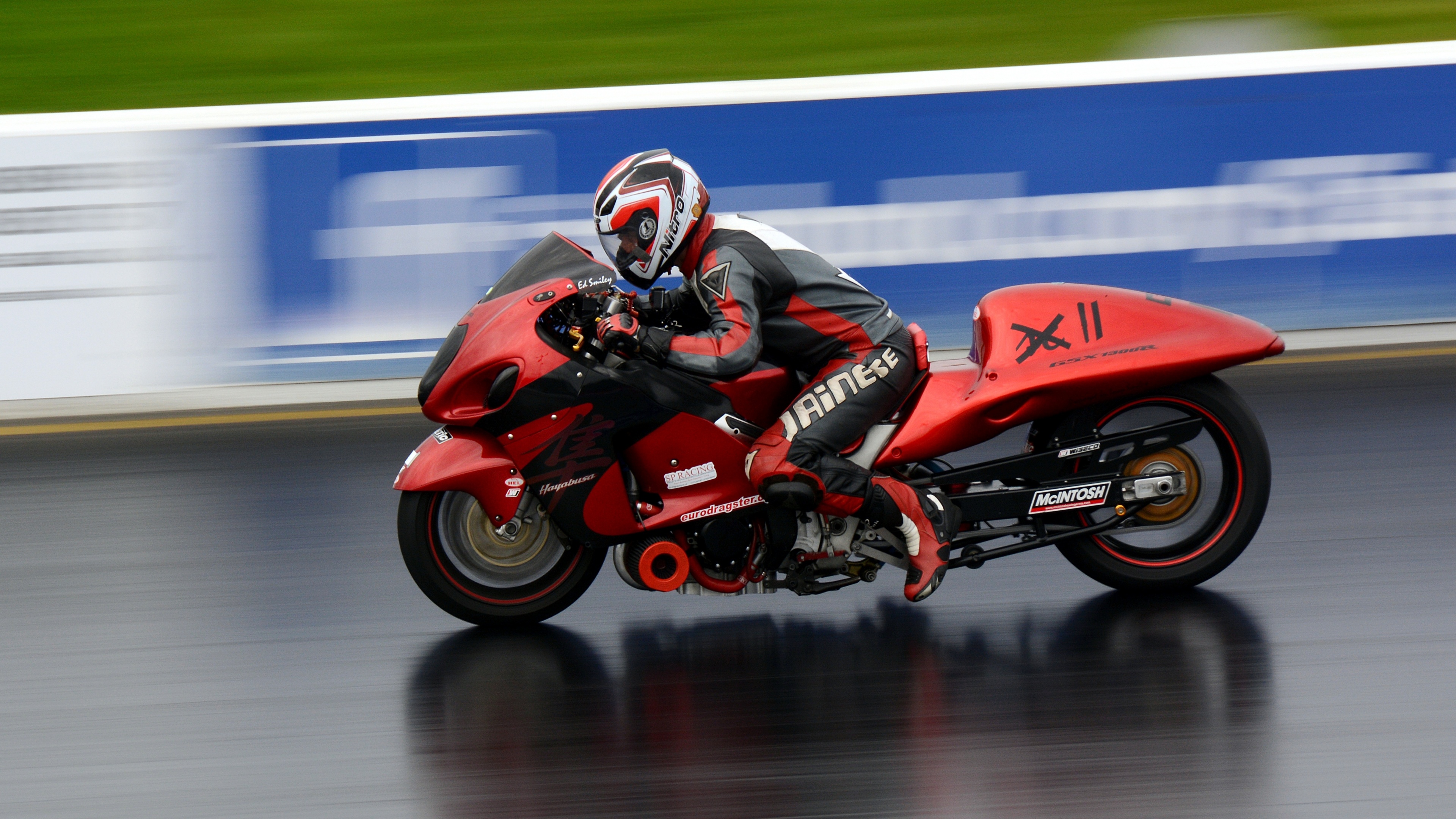 Red Racing Motorcycle Blasting Through Rainy Track in 4K - backiee