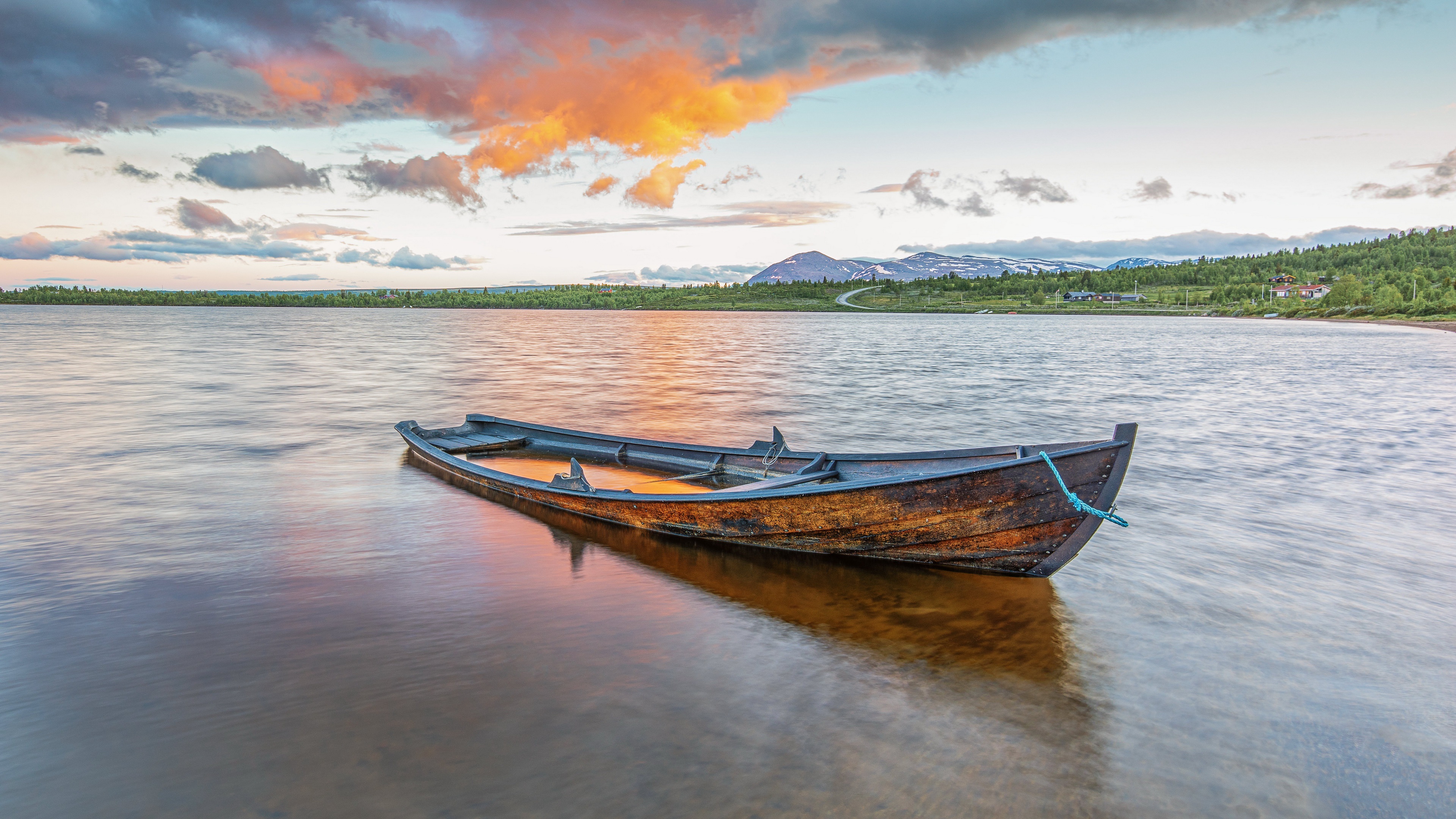 Solitary Weathered Boat Drifting on Calm Lake at Sunset in 4K - backiee