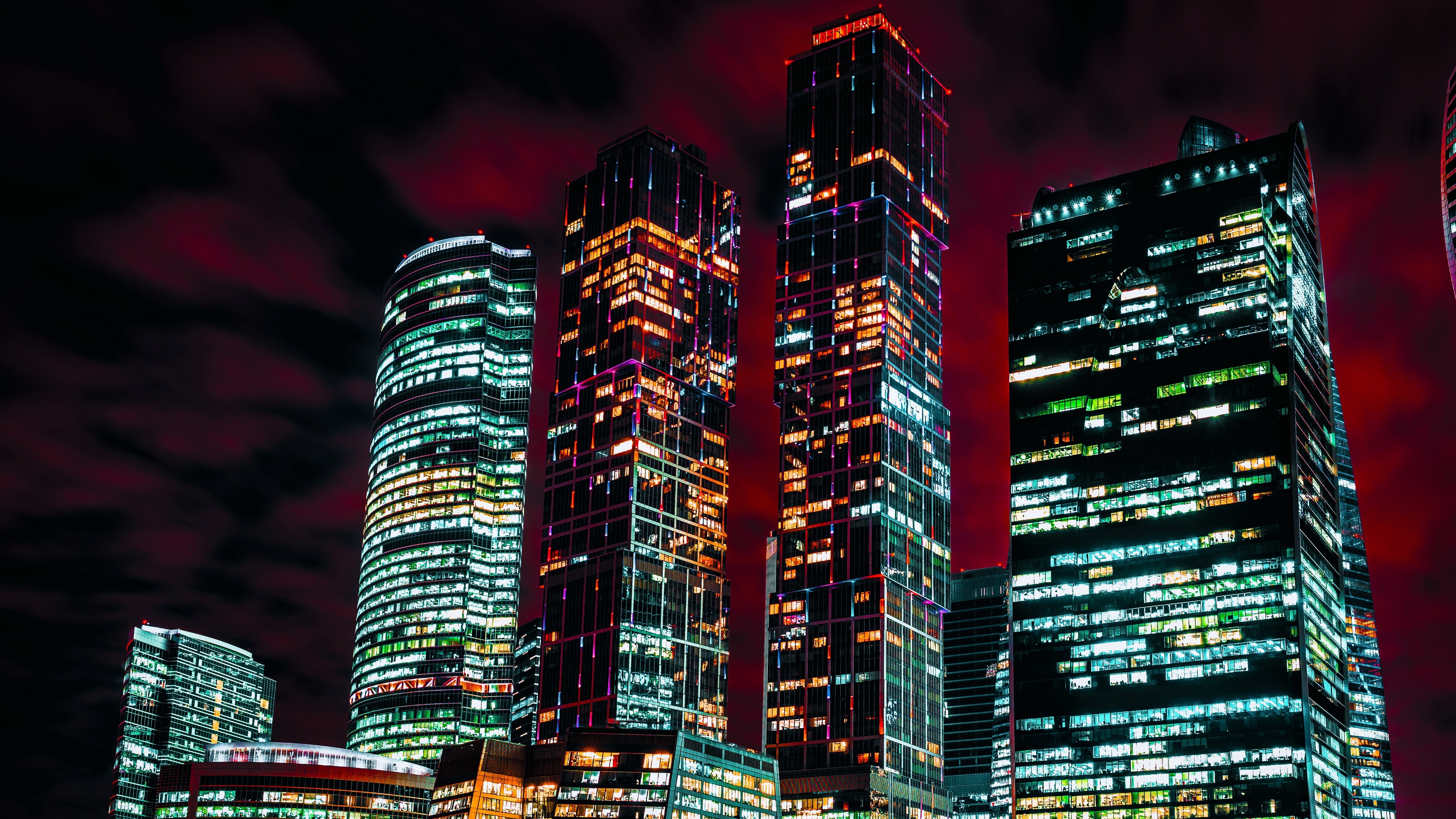 Skyscrapers Illuminated Against a Night Sky - backiee