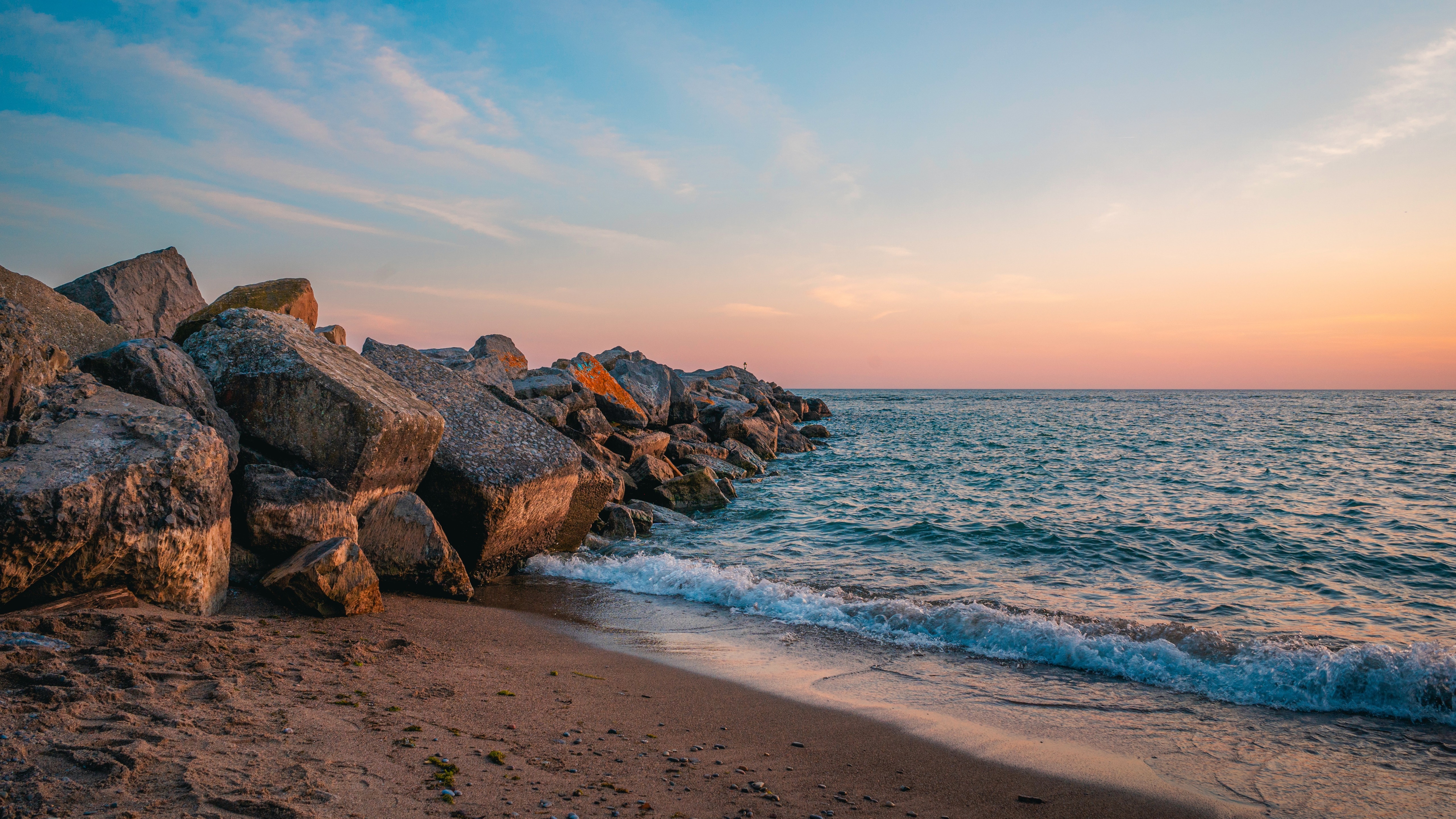 Sunset Serenity Along the Rocky Breakwater Shore - backiee