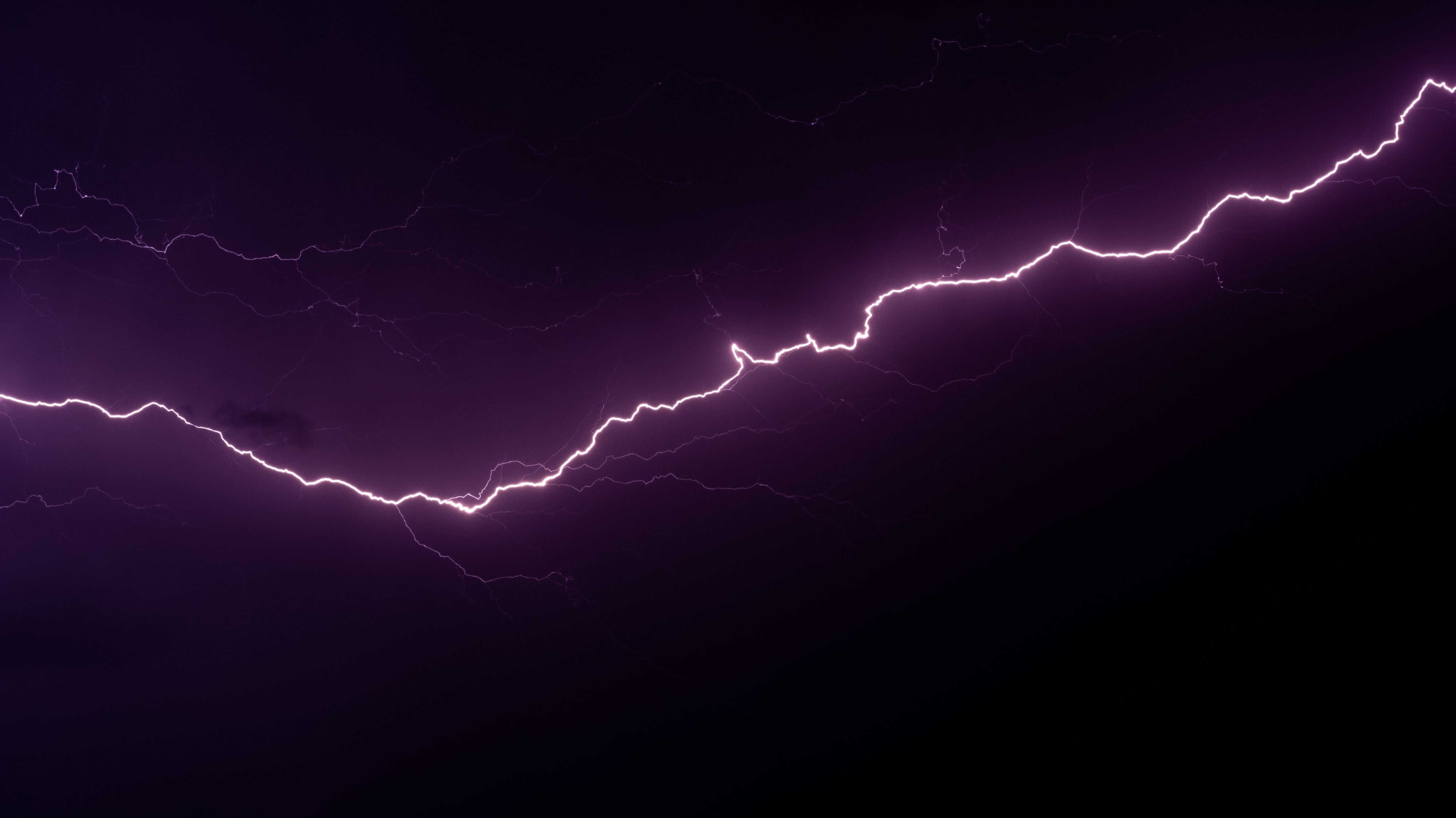 Electric Violet Lightning Cutting Across a Dark Night Sky - backiee