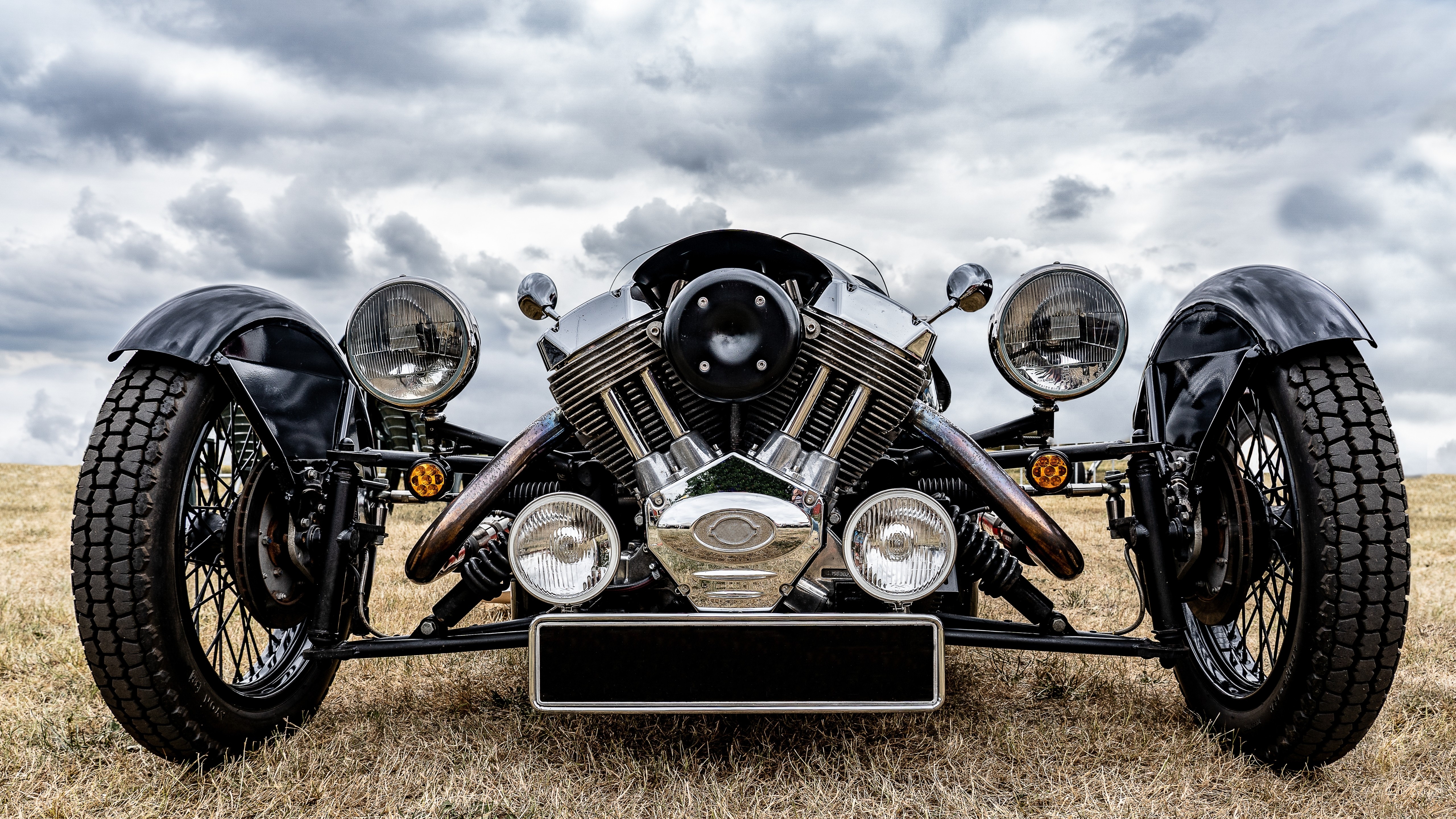 Morgan 3 Wheeler Front View Under Dramatic Cloudy Skies - backiee