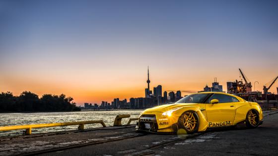 Sunset Silhouette of a Yellow Nissan GT-R - backiee