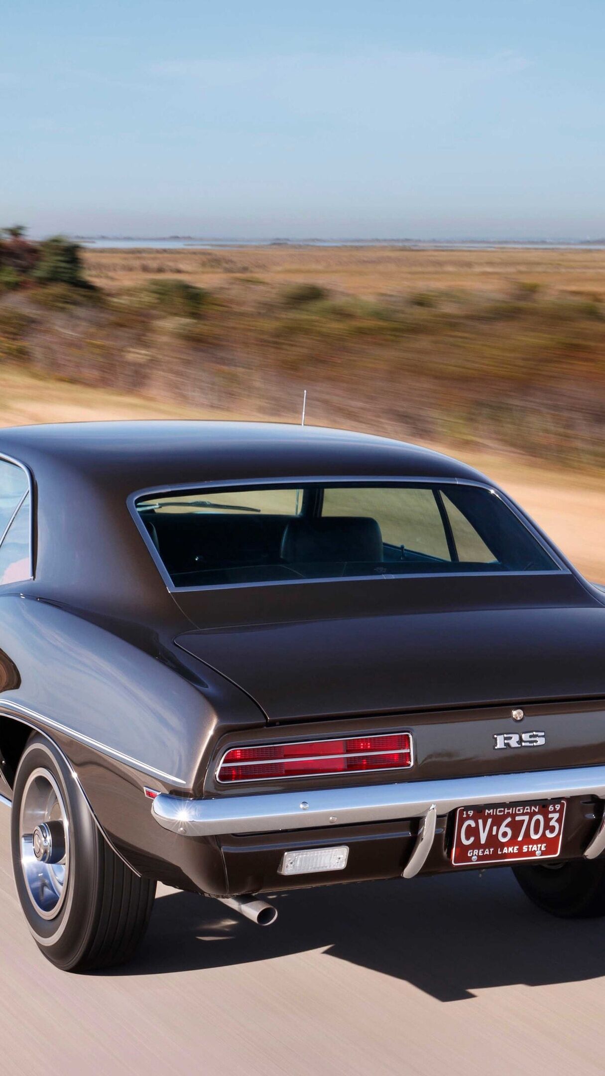 Classic Chevrolet Camaro Driving on Open Road - backiee