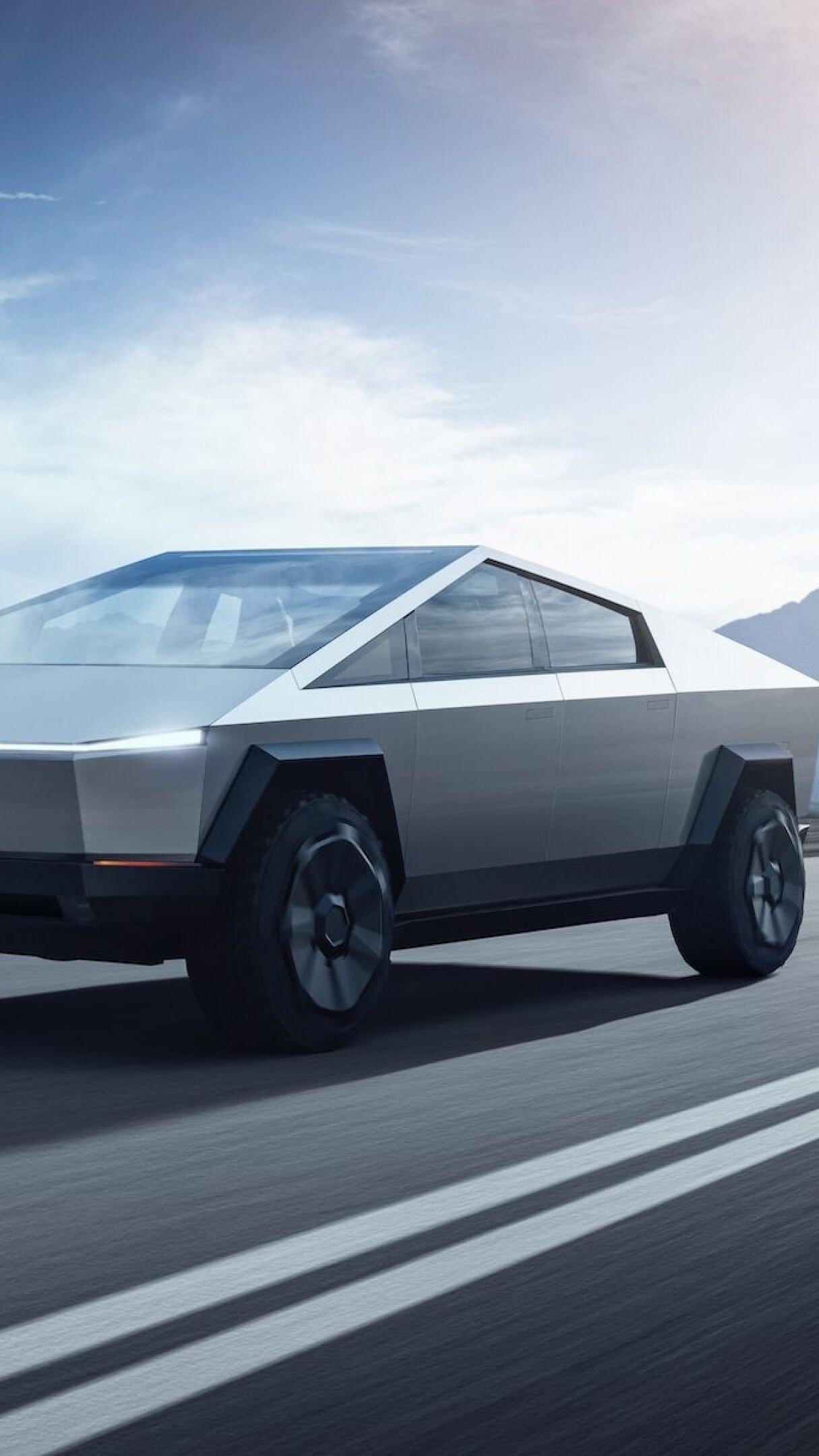 Tesla Cybertruck and remote desert highway with mountain ranges in the ...