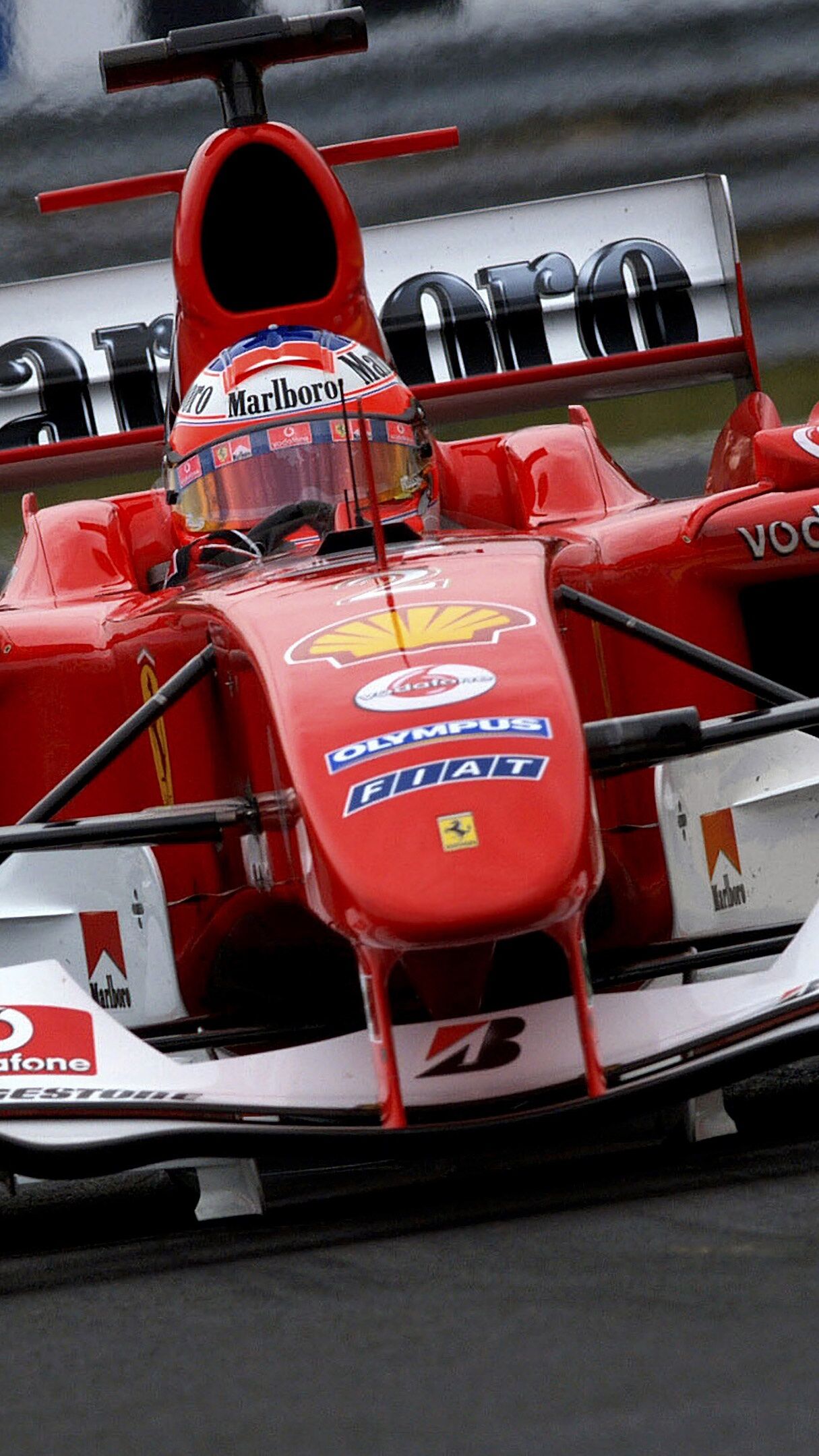 Scuderia Ferrari Formula 1 Machine Charging Through a Fast Corner - backiee