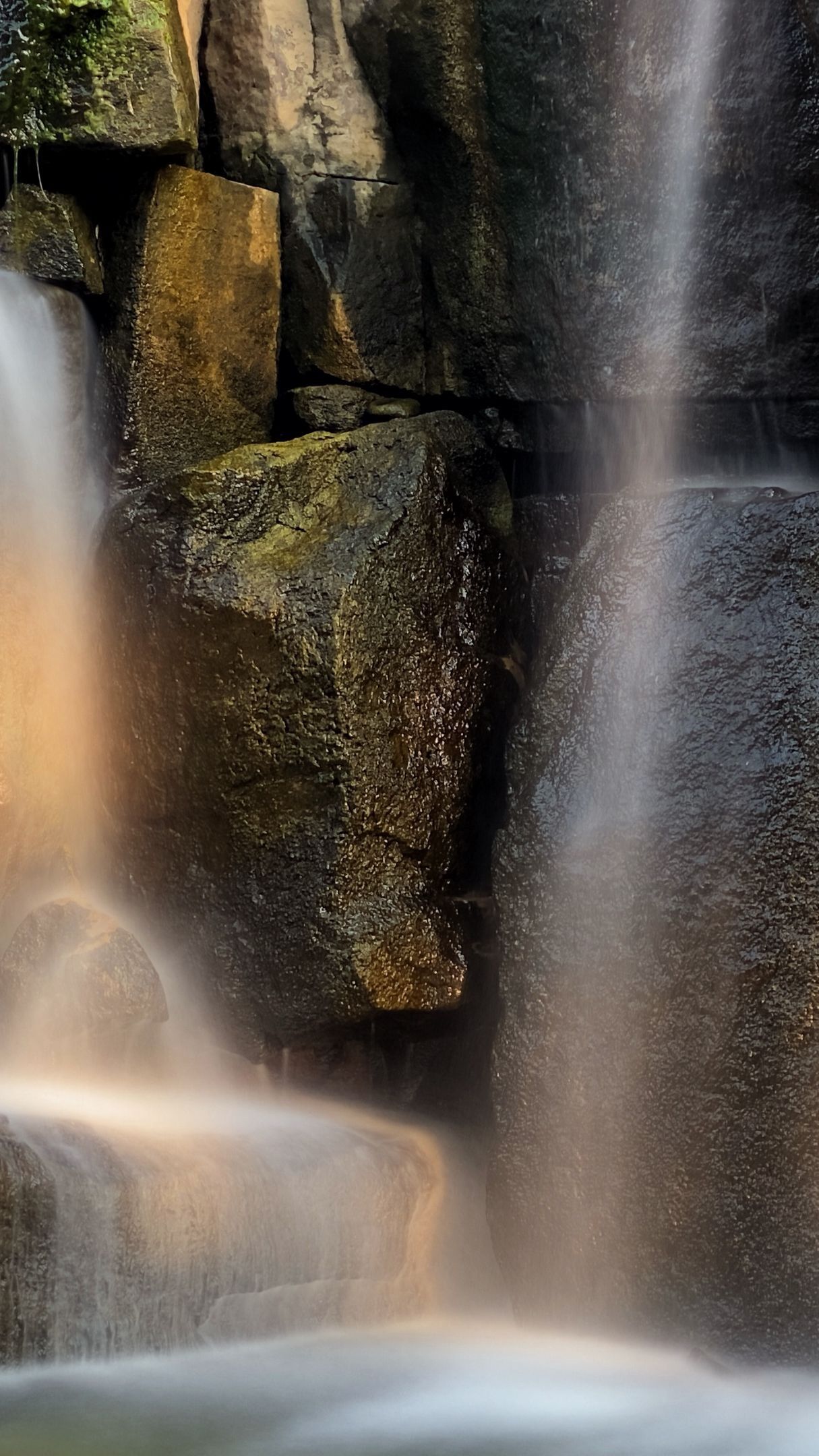 Golden Mist Waterfall Over Ancient Granite Boulders in Crisp 4K - backiee