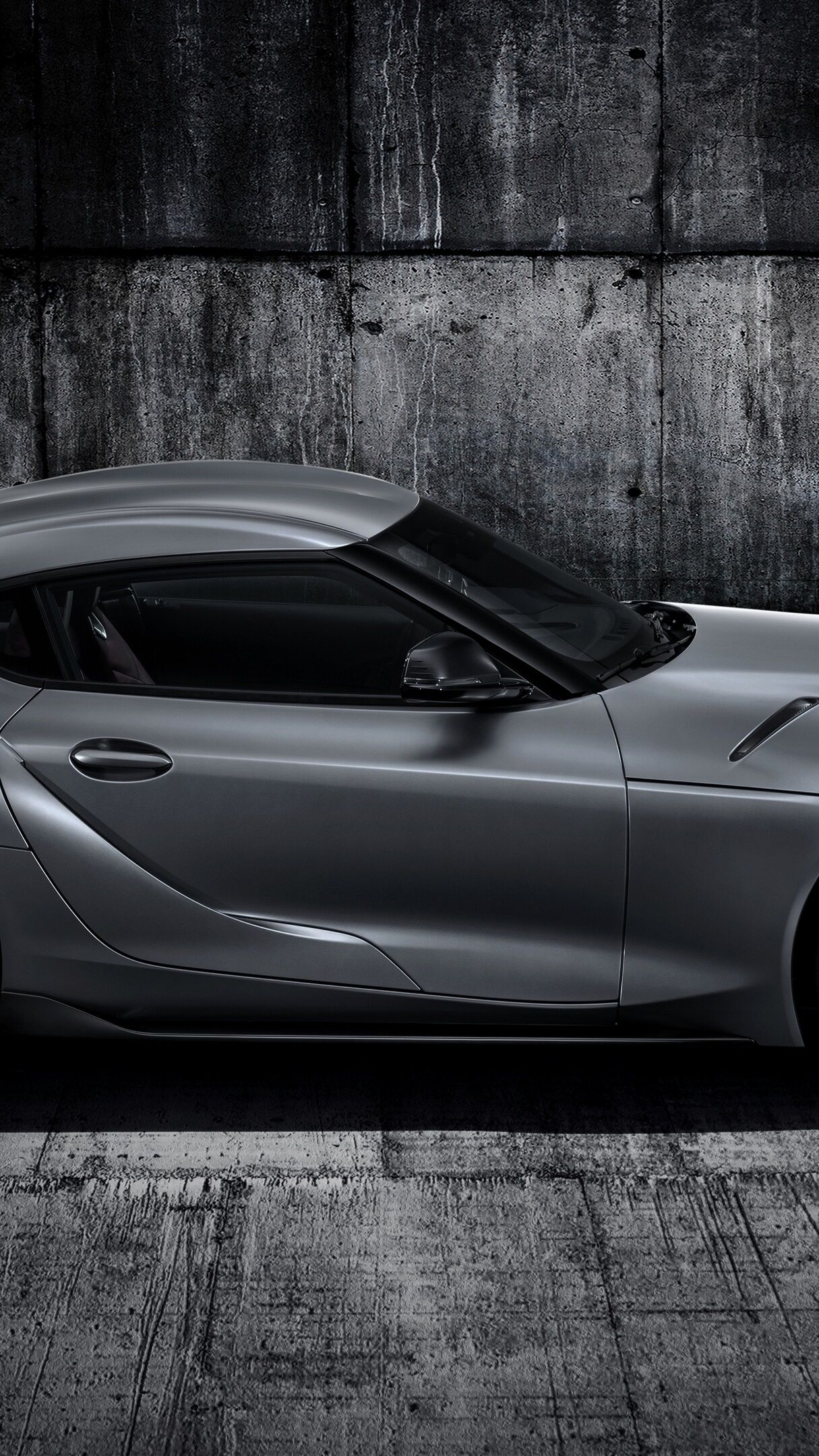 Monochrome Toyota GR Supra Silhouette in a Gritty Urban Garage - backiee