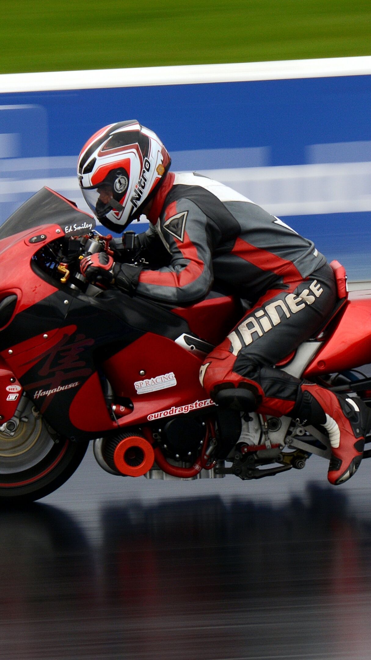Red Racing Motorcycle Blasting Through Rainy Track in 4K - backiee