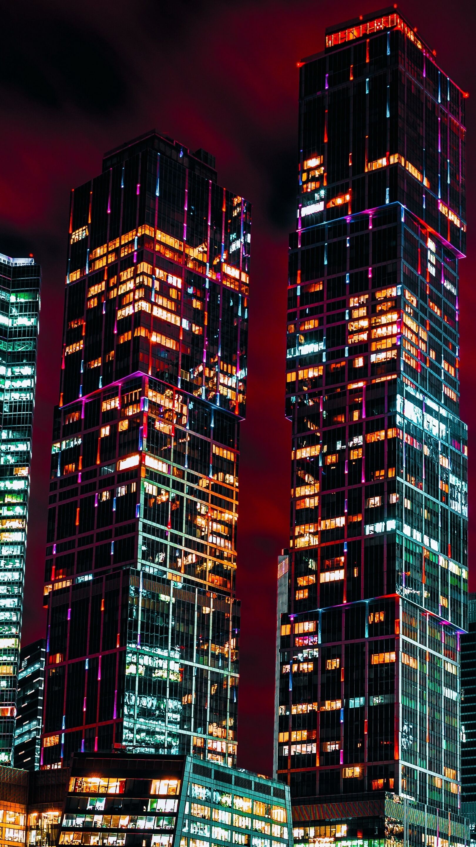 Skyscrapers Illuminated Against a Night Sky - backiee