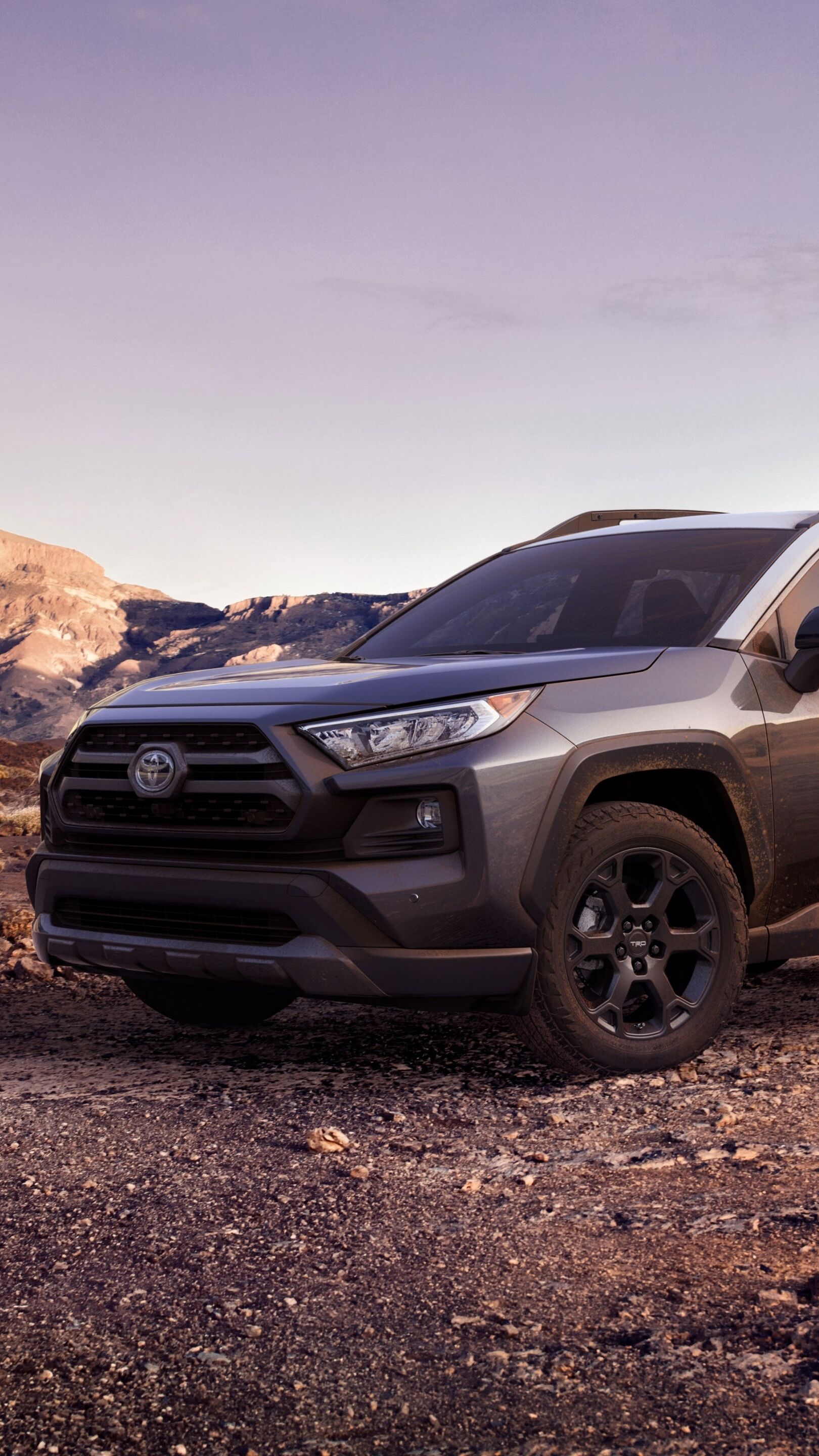 Toyota RAV4 SUV at Sunset in Rugged Desert Mountains - backiee
