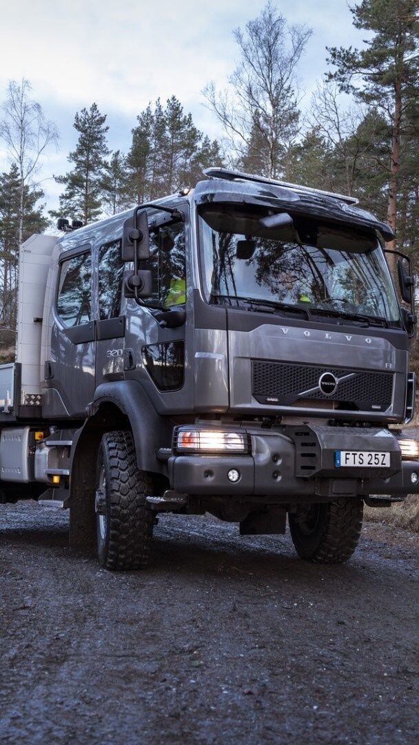 Volvo Truck in Serene Forest Setting - backiee