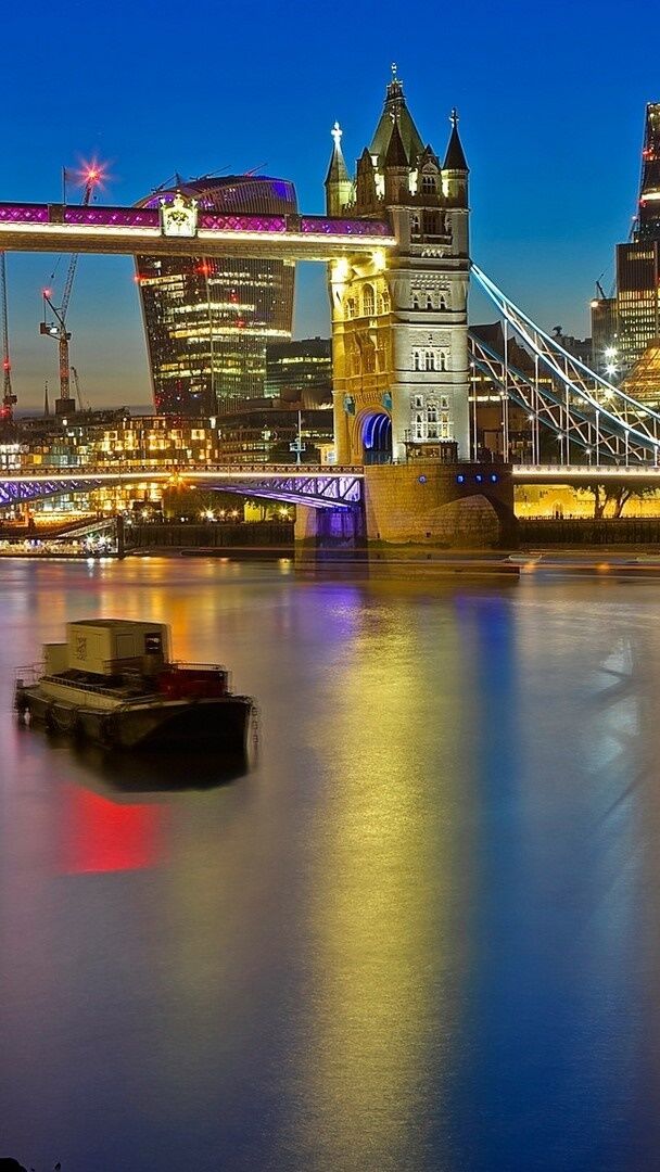 Tower Bridge Glowing Over the River Thames at London Dusk - backiee