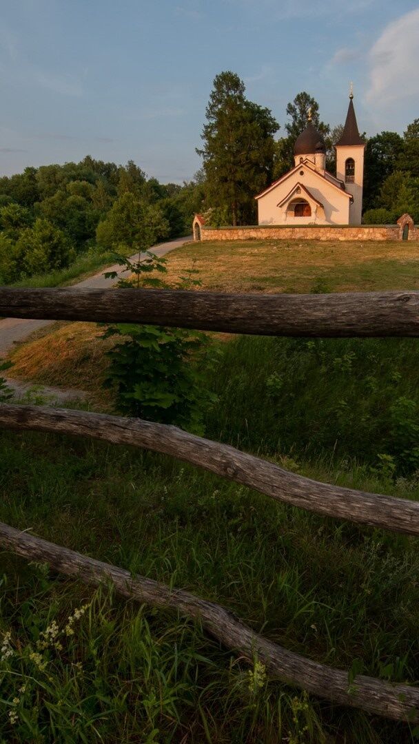 Hilltop Chapel Beyond the Rustic Fence at Golden Hour - backiee